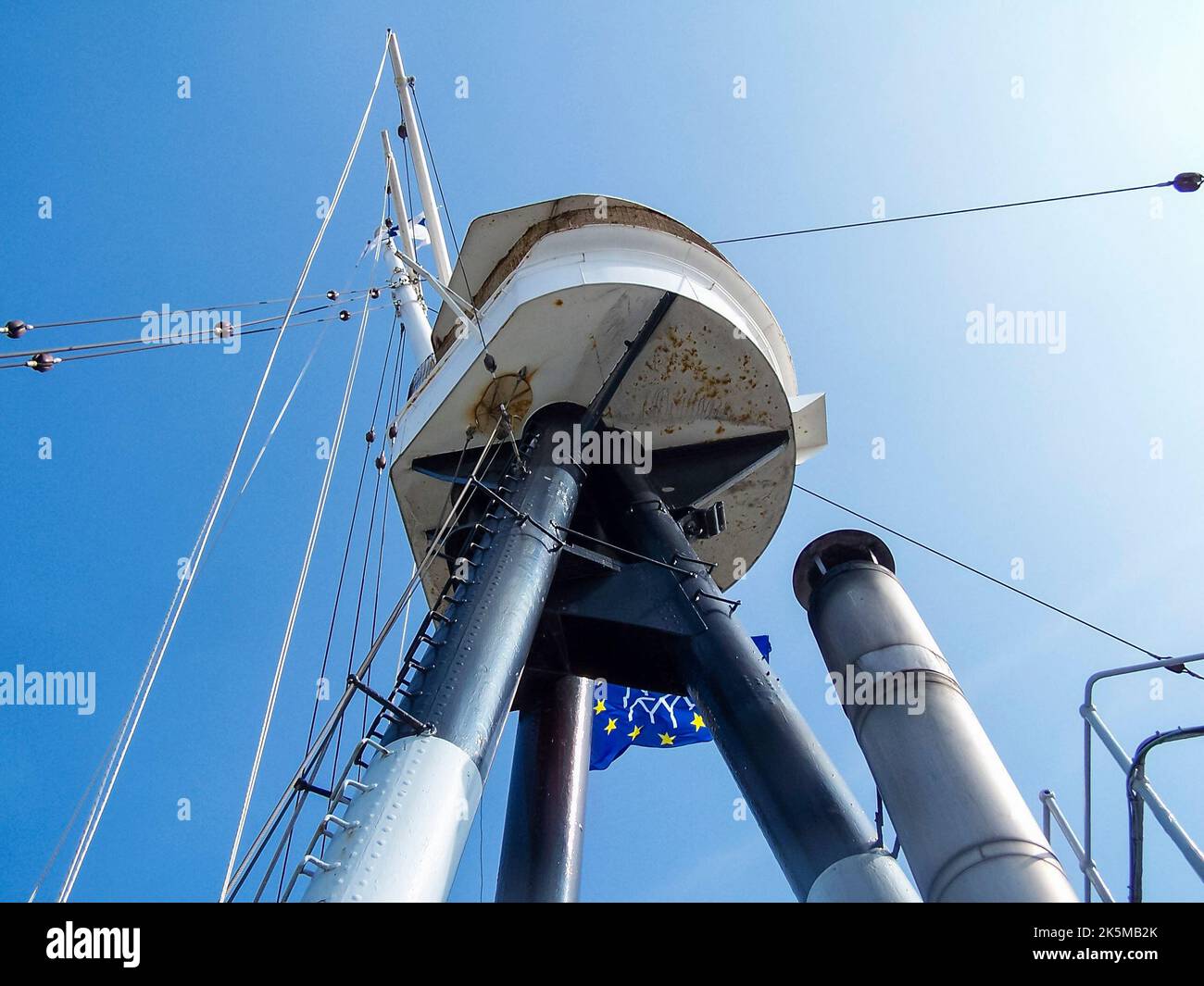 Crows nest lookout against a blue sky on an old Royal Navy warship ...