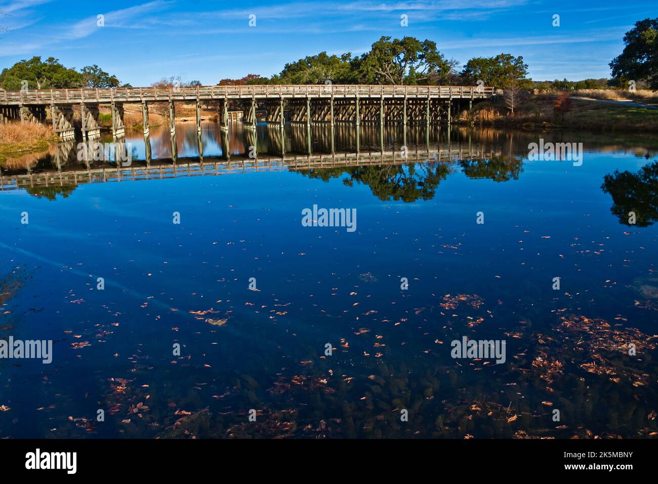 Bridge Reflecting In Water of Calm Lake at Boot Ranch, Fredericksburg ...