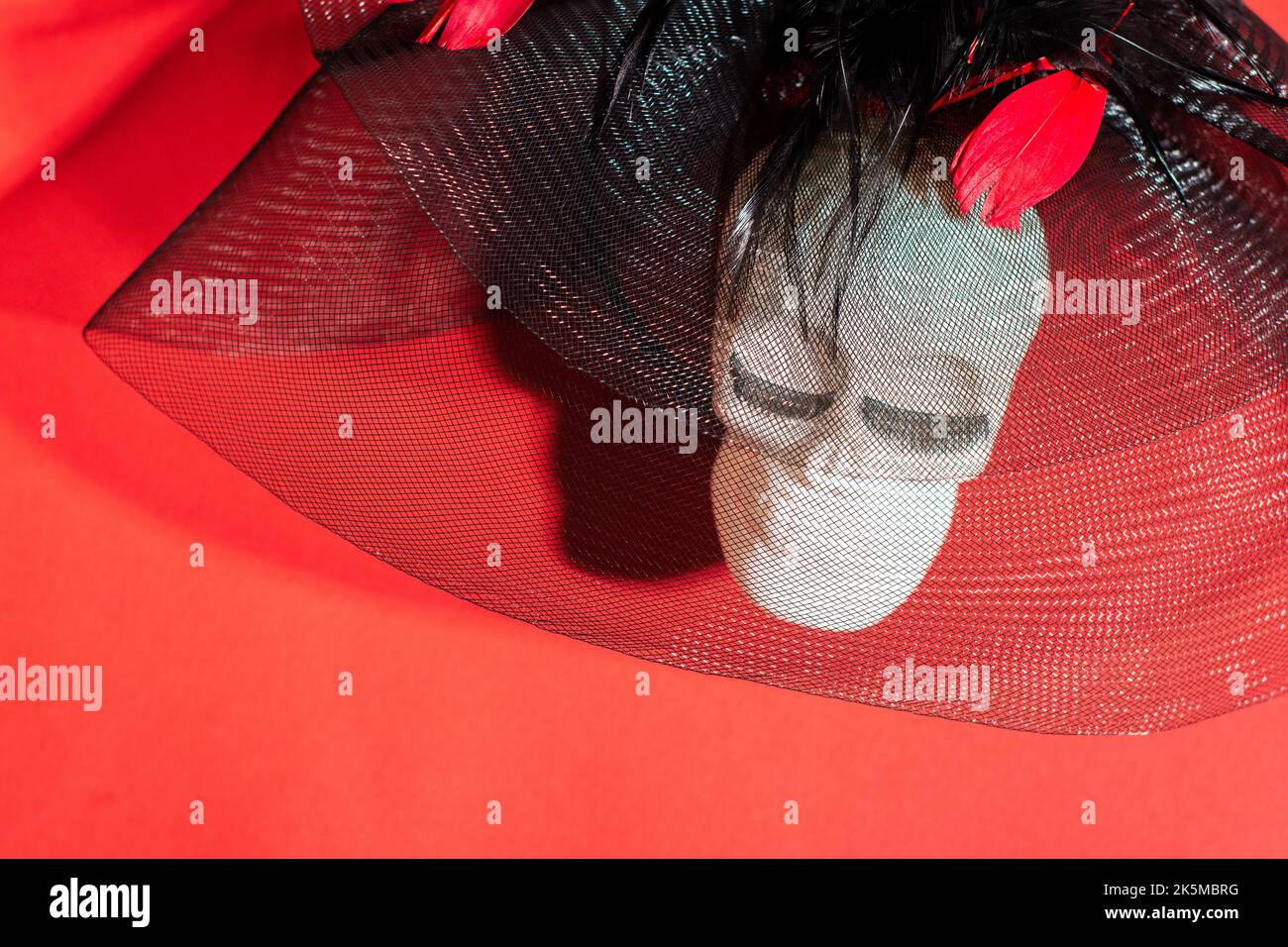 Cheerful Human skull with eyelashes on a red background Stock Photo - Alamy