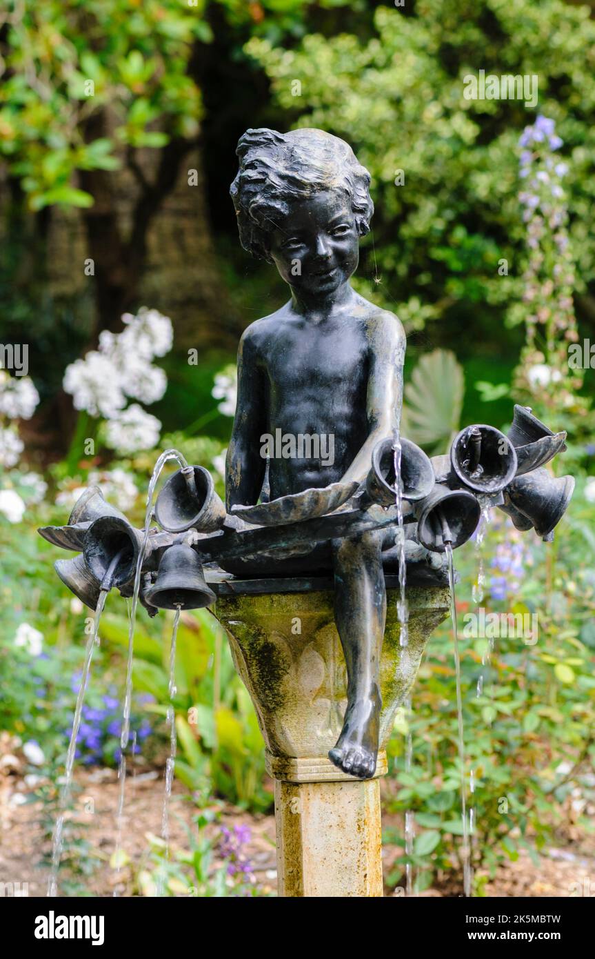 Bronze cherub water feature in a formal garden Stock Photo - Alamy