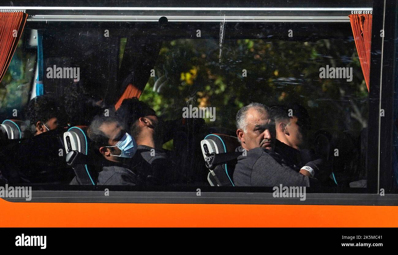 A bus carrying a group of people thought to be migrants arrives at the ...
