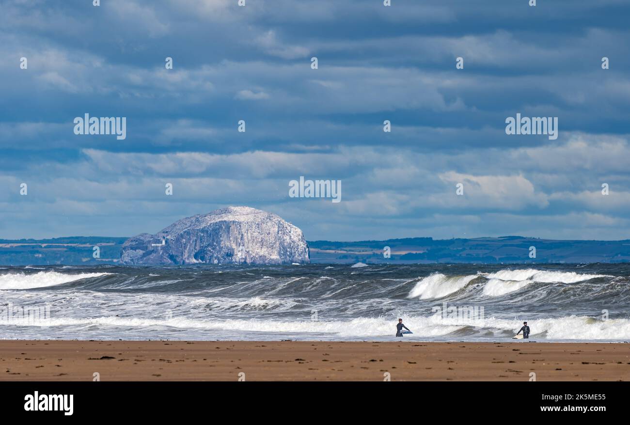 Surfers in the Firth of Forth on a windy day with big waves with the ...