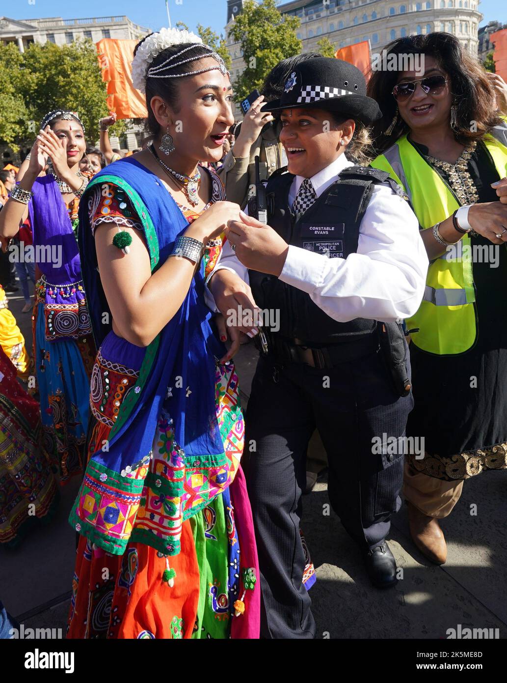 A police officer dances with members of the public during the Diwali on ...