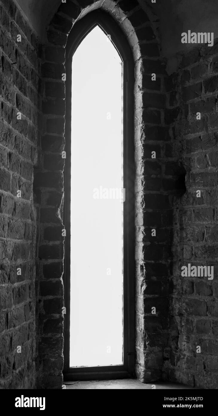 old window in the castle. window with bars in an old brick wall Stock ...