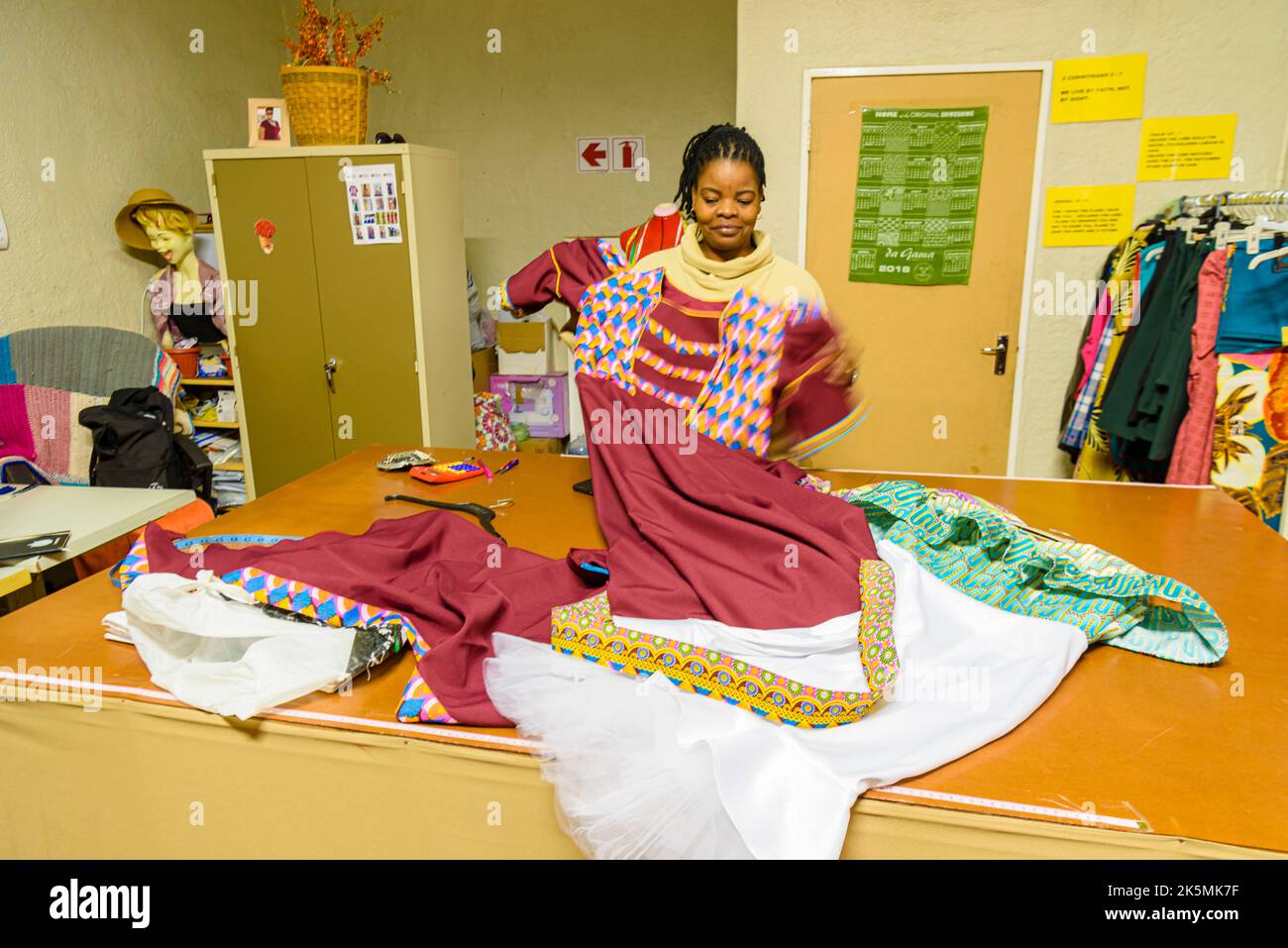 A woman makes traditional dresses in a dressmakers shop, Otjiwarongo ...