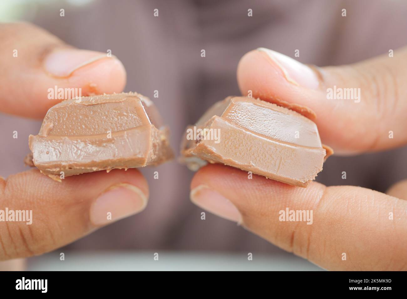 Hand breaking chocolate bar hi-res stock photography and images - Alamy