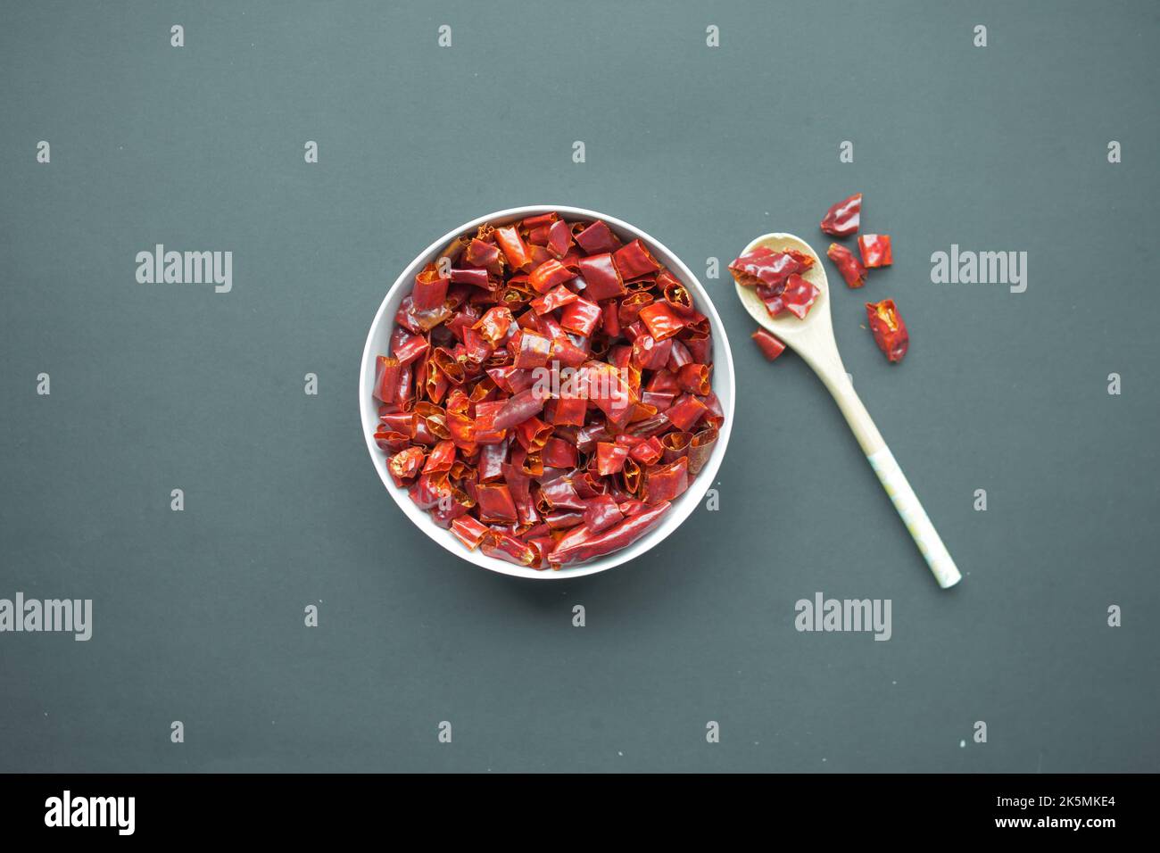 red chili pepper flakes in a bowl on black background Stock Photo - Alamy