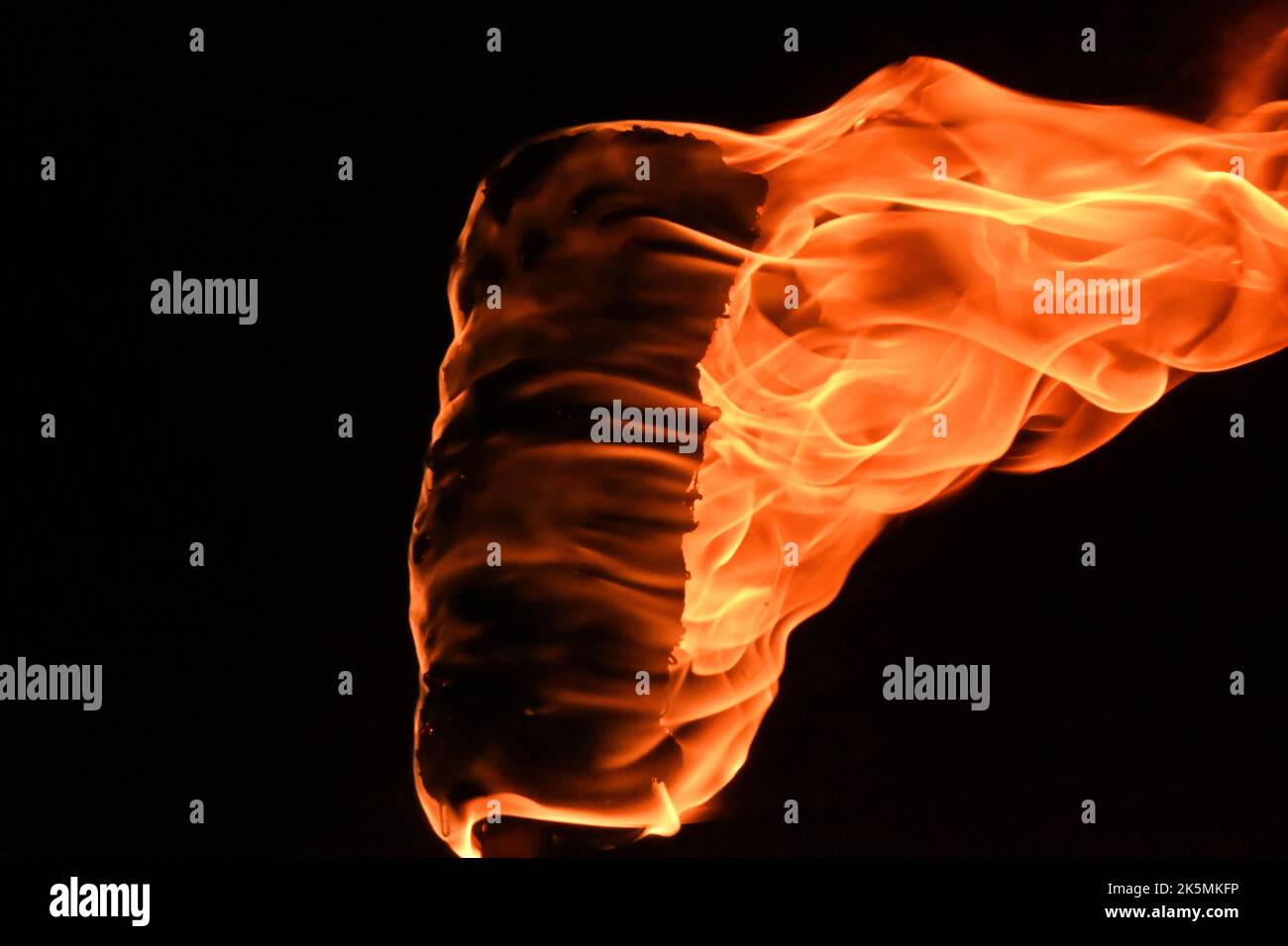 A flaming torch on the black background at night Stock Photo - Alamy