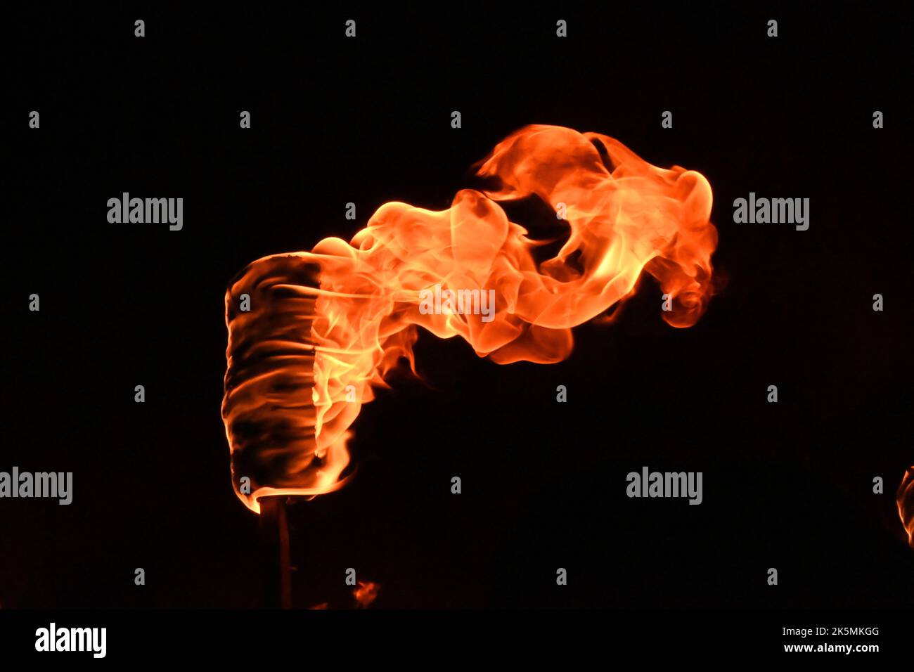 A flaming torch on the black background at night Stock Photo - Alamy