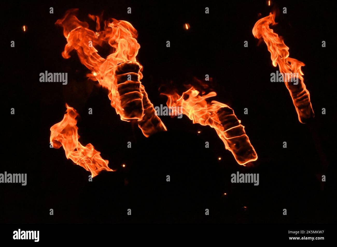 The flaming torches on the black background at night Stock Photo - Alamy