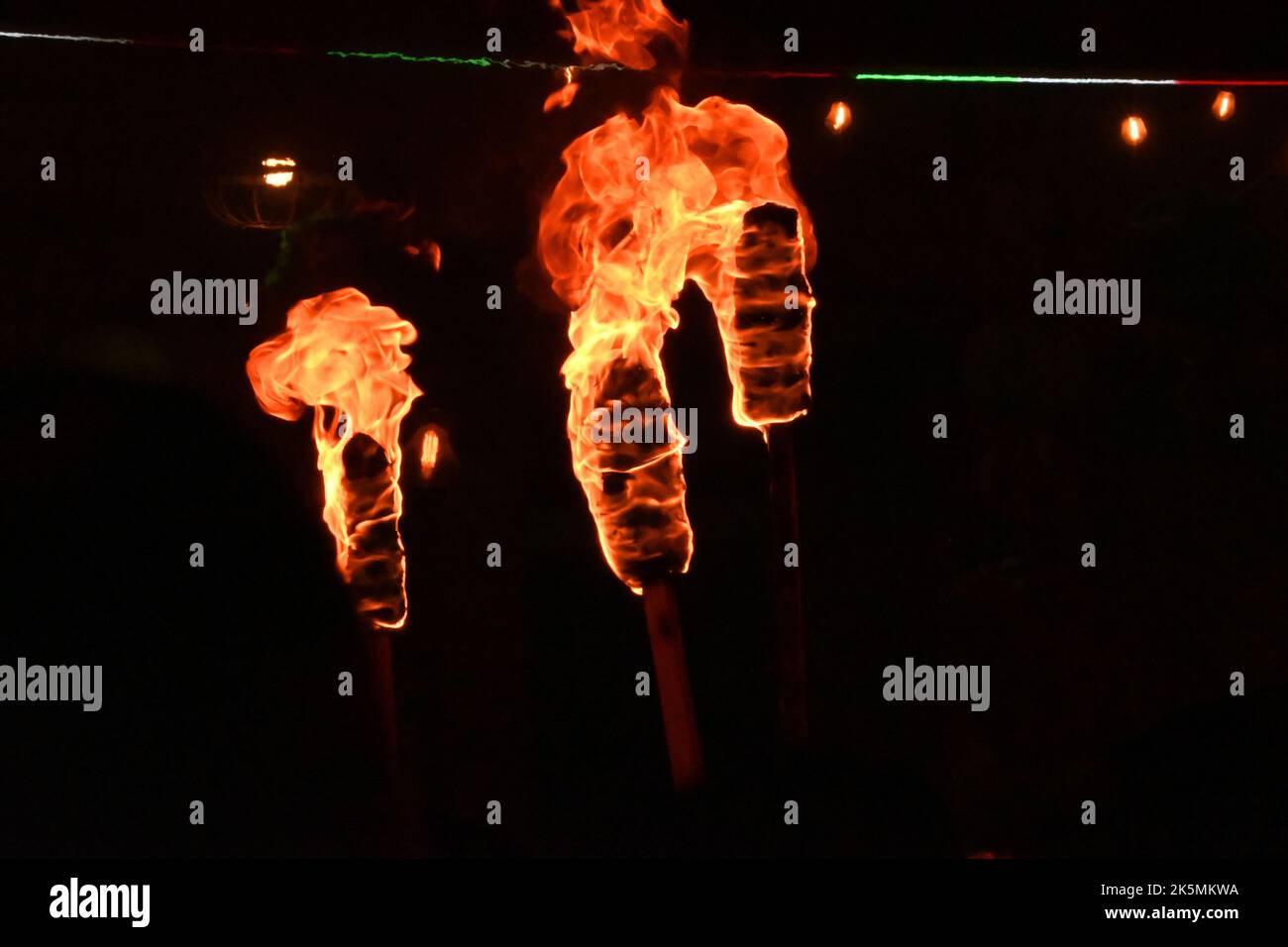 The flaming torches on the black background at night Stock Photo - Alamy