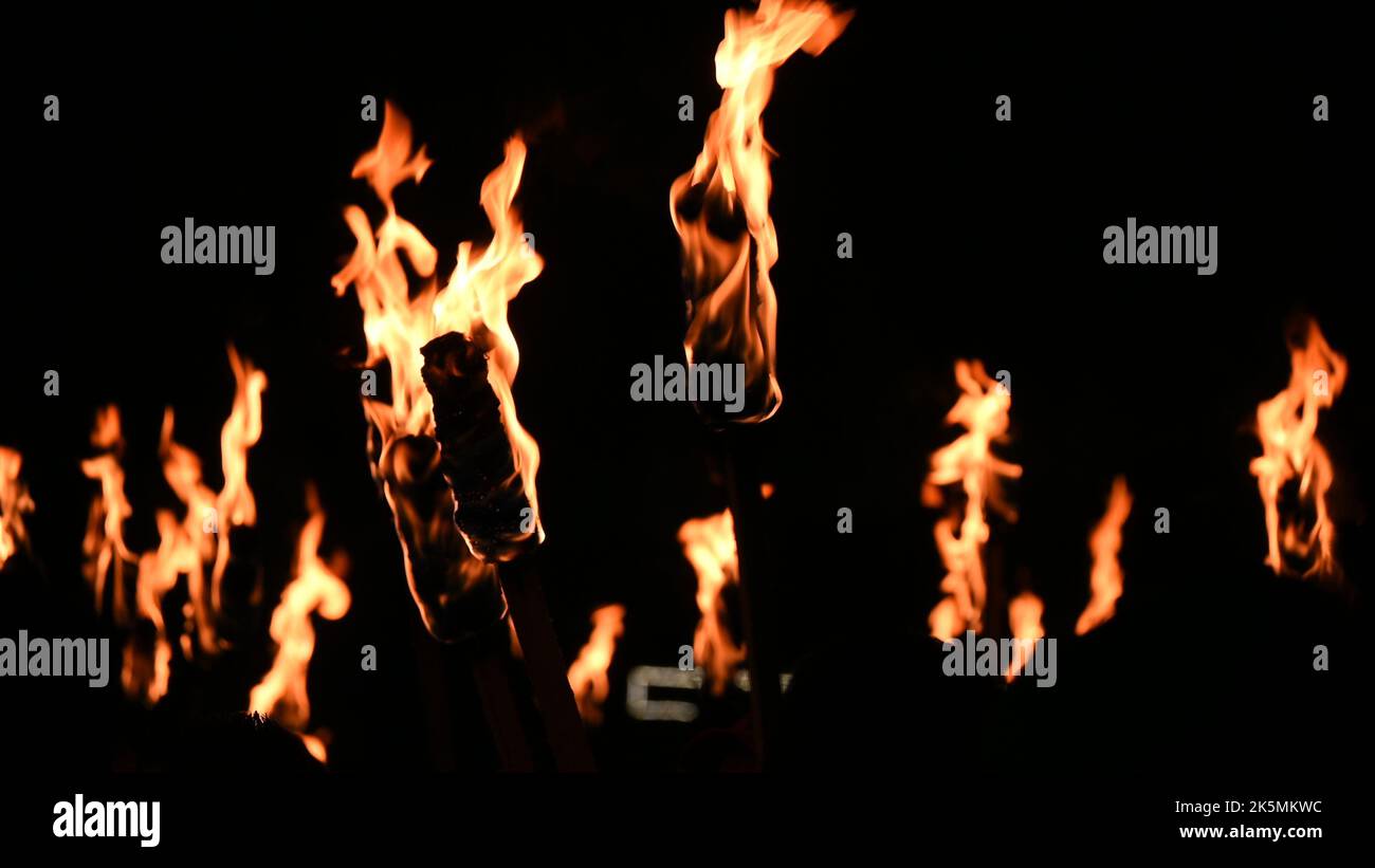 The flaming torches on the black background at night Stock Photo - Alamy