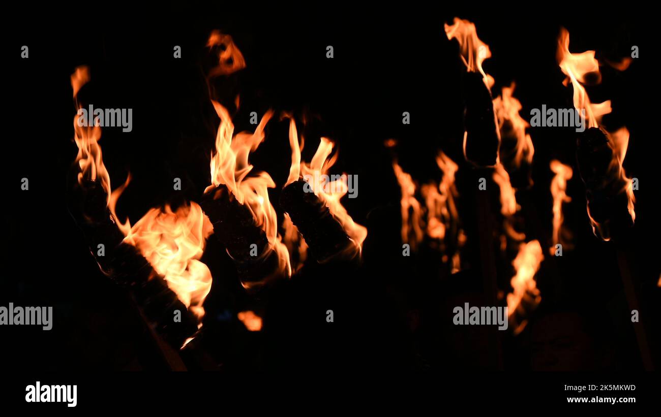 The flaming torches on the black background at night Stock Photo - Alamy