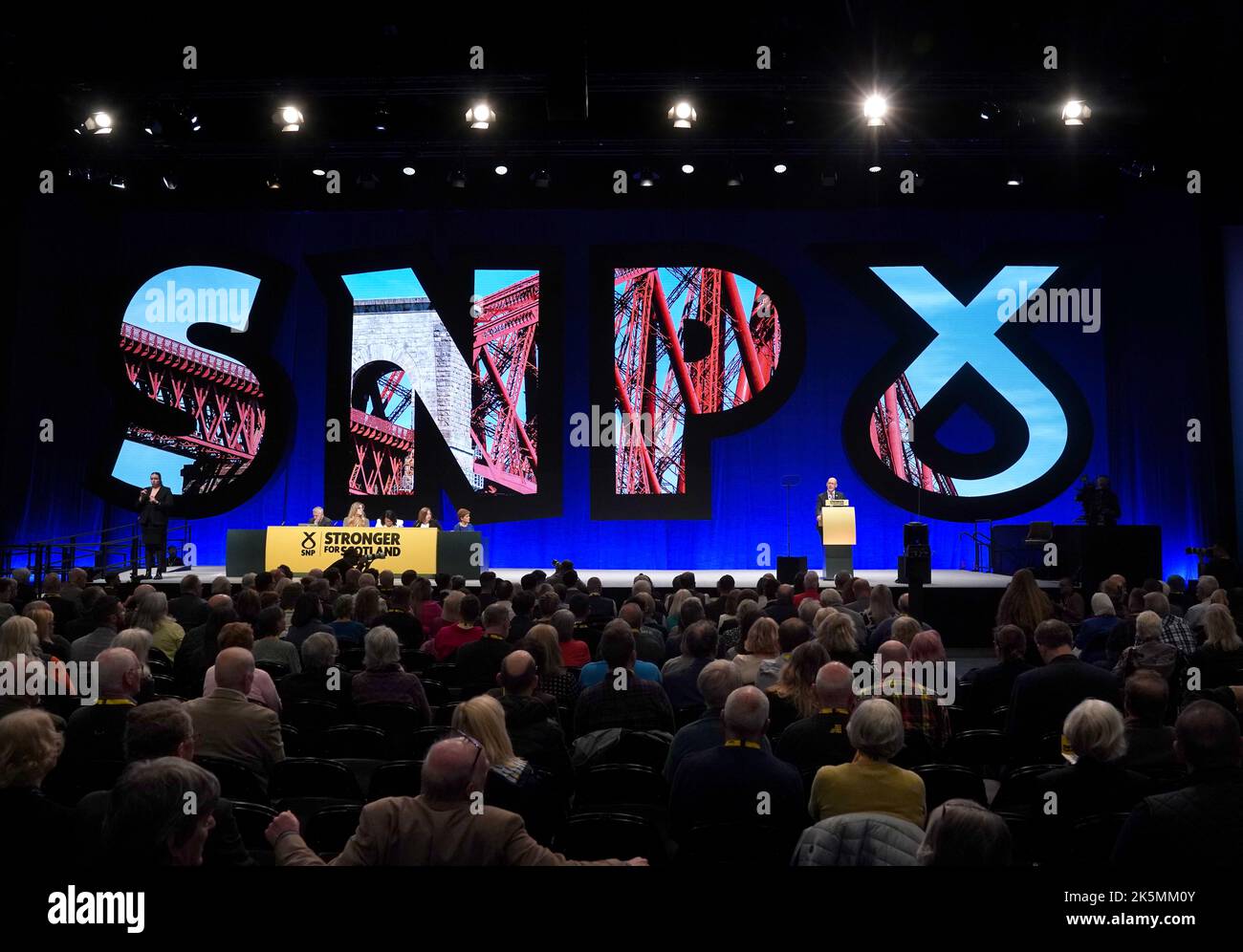 First Minister Nicola Sturgeon watches Deputy First Minister John Swinney during his speech at ...