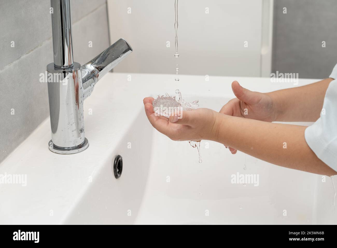 Close up children's hands wash grown crystal.. Chemical experiment on ...