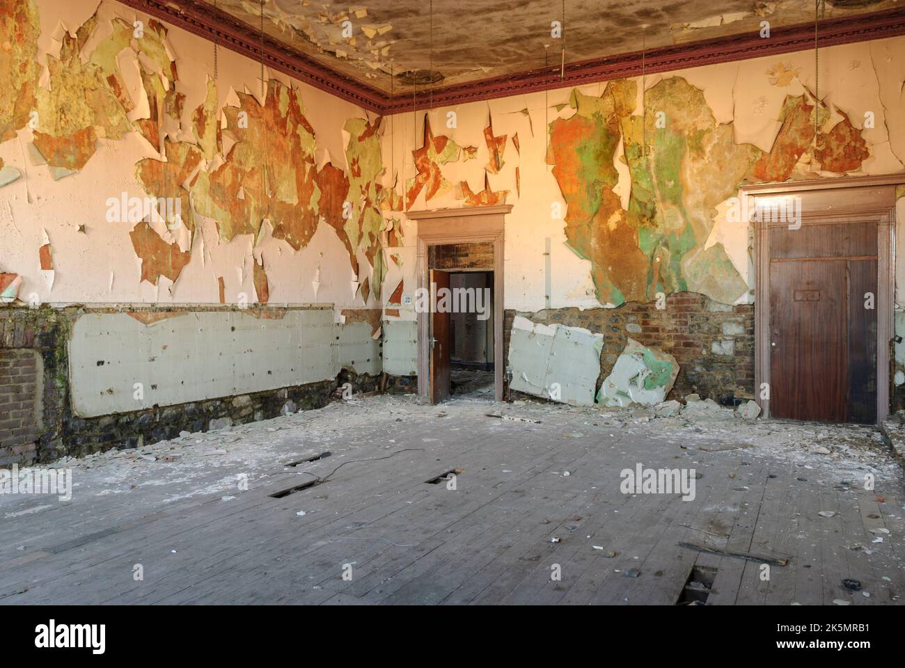 Plaster falling off the walls of an abandoned building with high ...