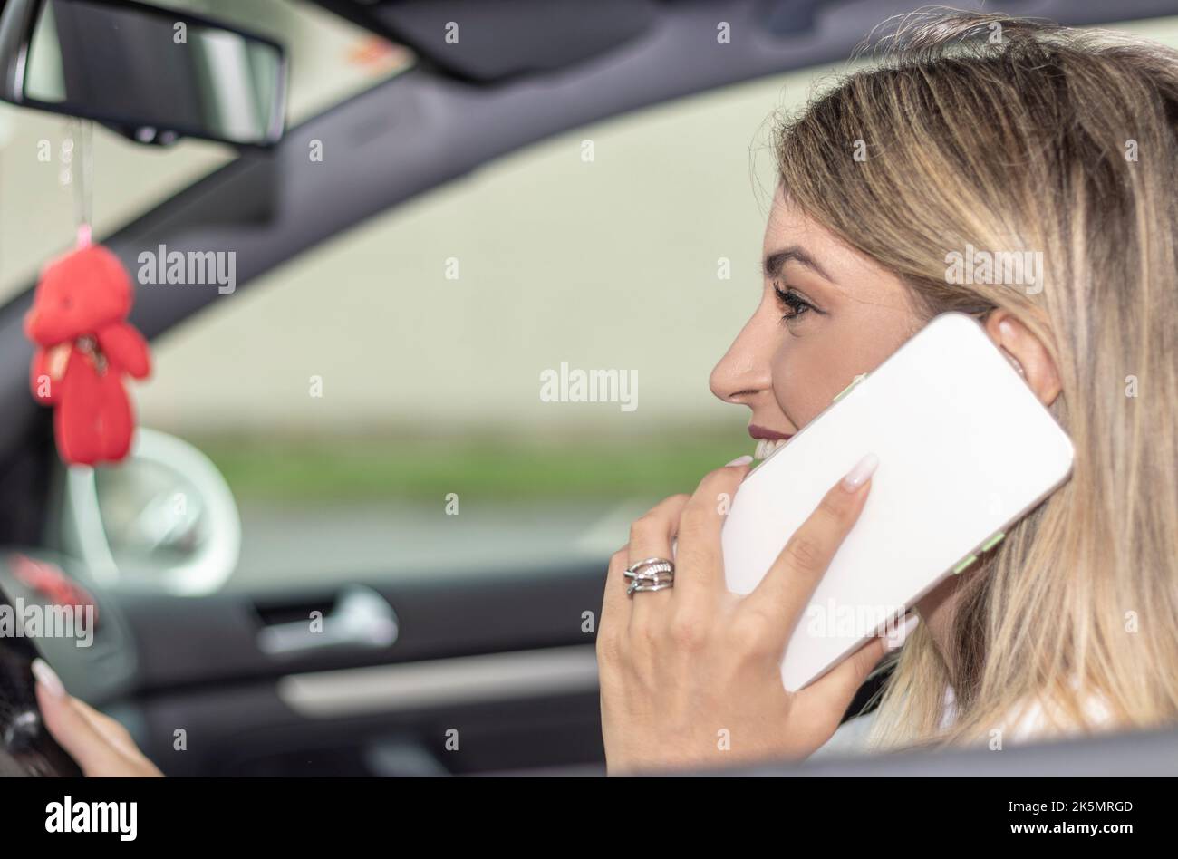 Woman using mobile phone while driving a car. danger concept Stock ...