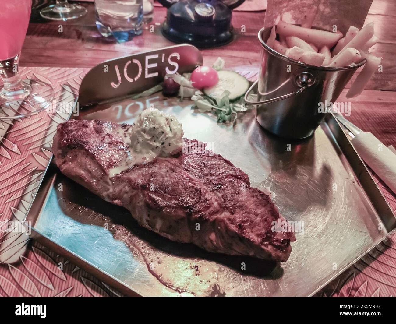 Massive steak with a pot of chips at the famous Joe's Steakhouse ...