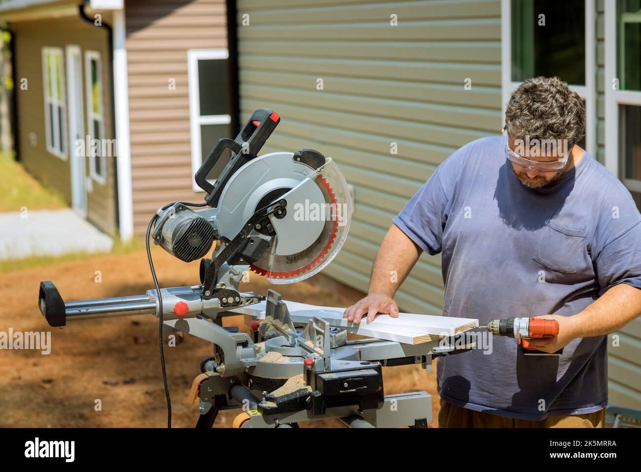 In order to connect wooden boards for construction work carpenter is ...