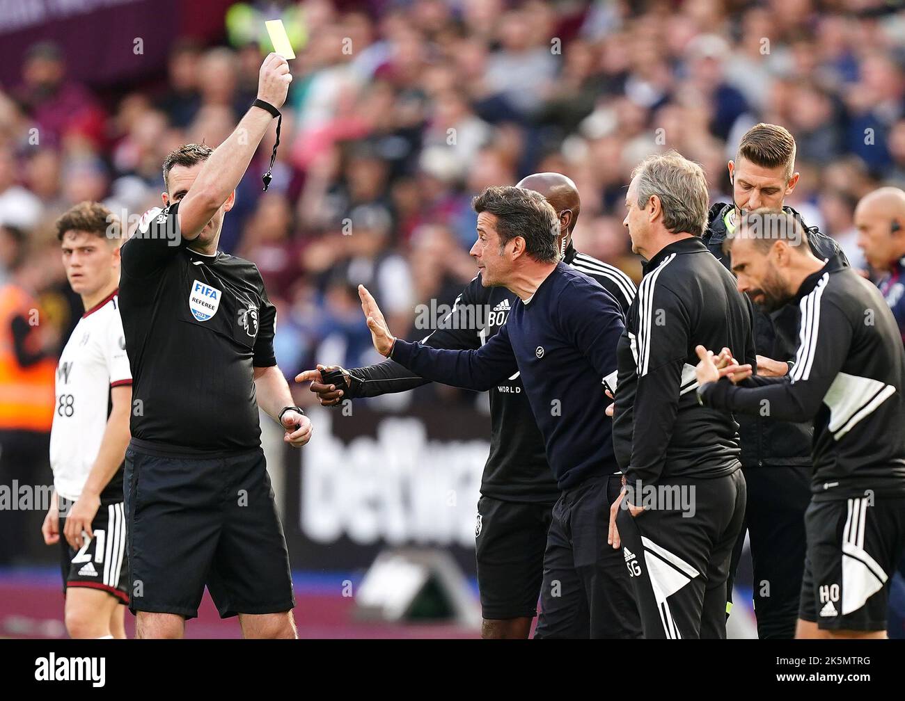 Fulham manager Marco Silva is shown a yellow card after arguing with ...
