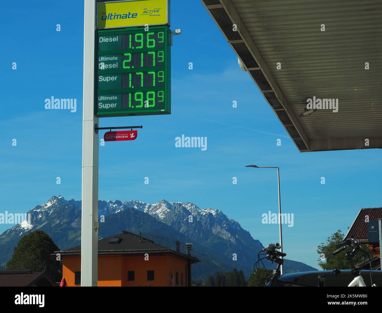 A petrol price indicator sign in a petrol station in the background of ...