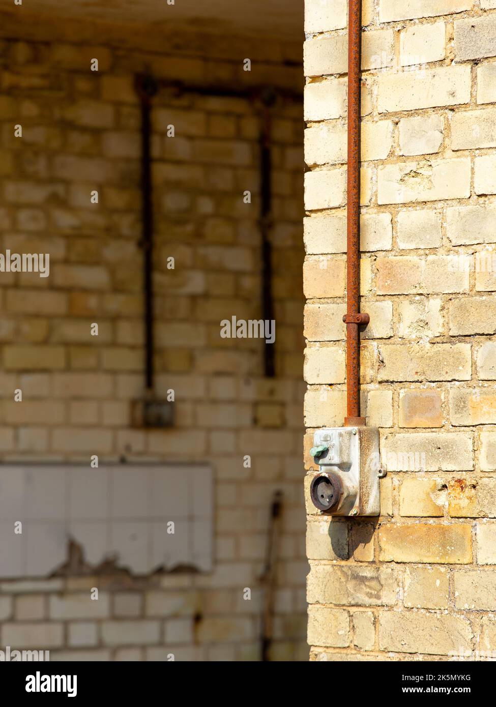 Detail of electrical switch and distressed elements in small building ...
