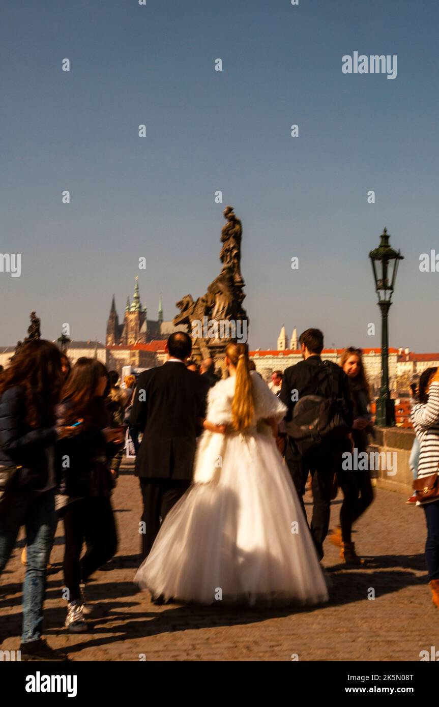 Ethereal bridal gown on the Gothic Charles Bridge with Cathedral of St ...