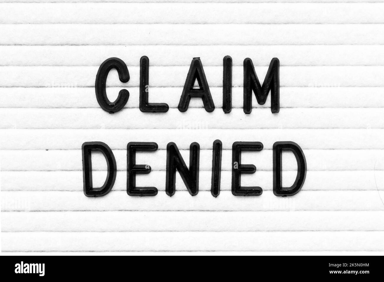 Black color letter in word claim denied on white felt board background ...