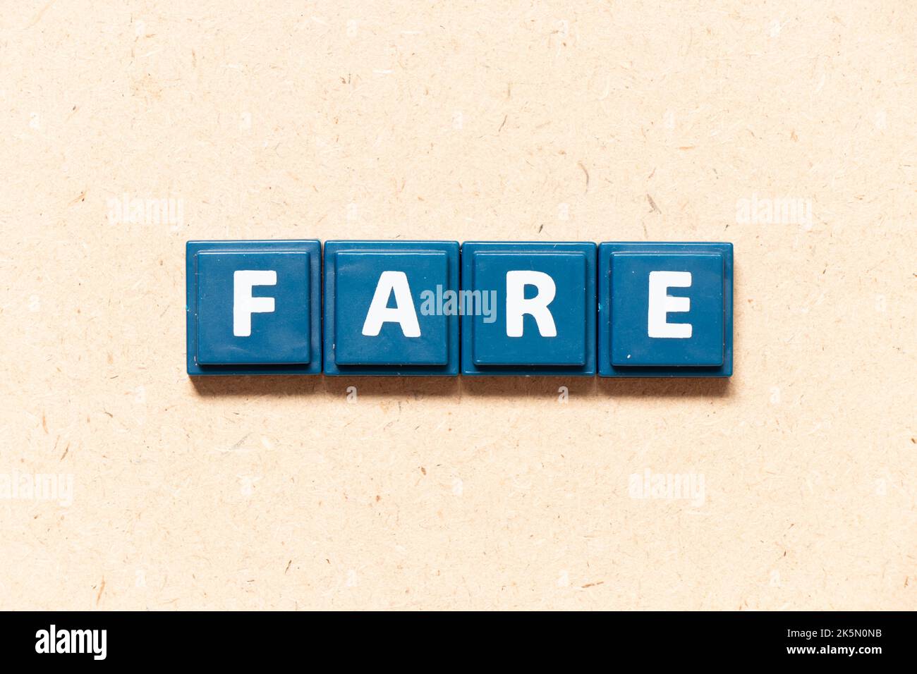 Tile letter in english word fare on wood background Stock Photo - Alamy