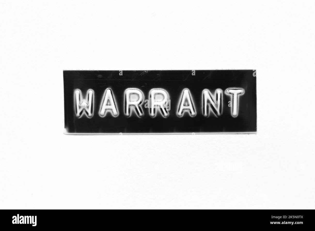 Black color banner that have embossed letter with word warrant on white ...