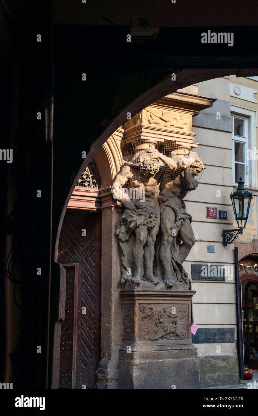 Atlas lean forward to support the heavy load of a building in Prague ...