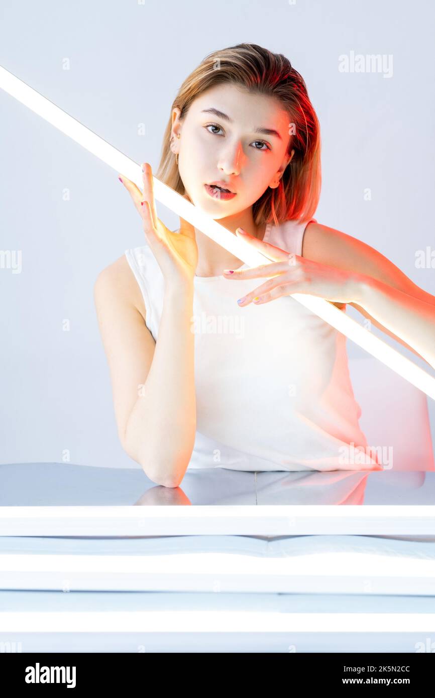 Futuristic beauty. Skin care. Light therapy. Art portrait of confident ...