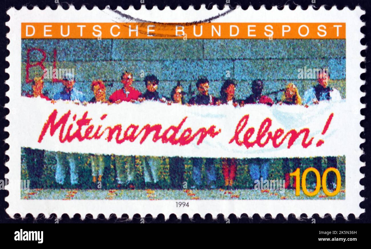 GERMANY - CIRCA 1994: a stamp printed in Germany shows foreigners in ...