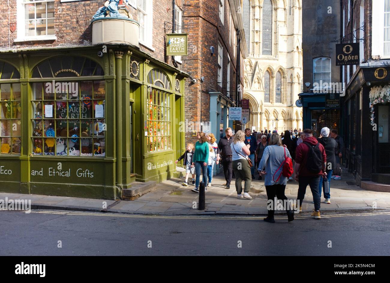 High Petergate in the centre of York with many tourists headiing to an ...