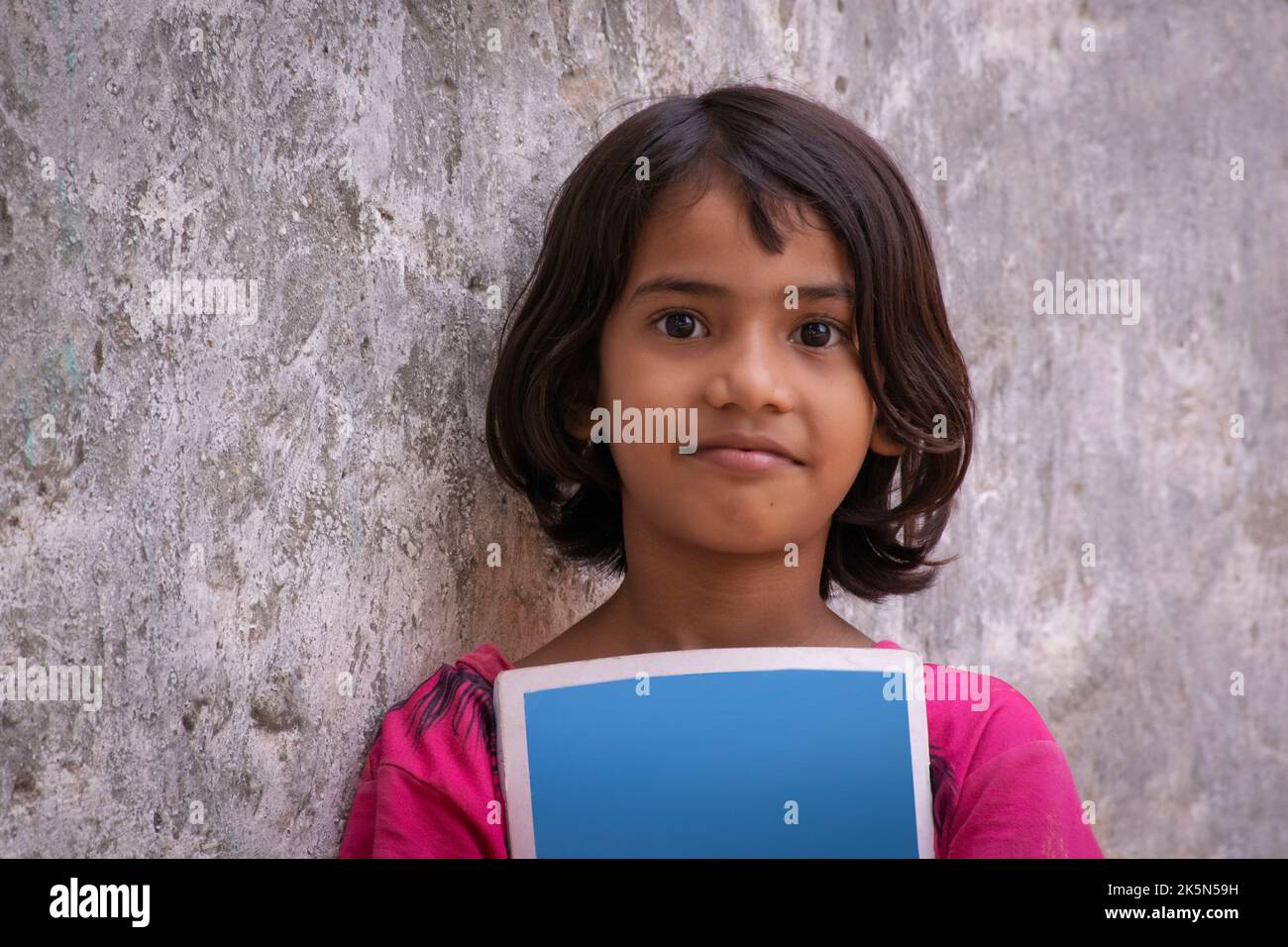 portrait of young smiling Indian girl holding books Stock Photo - Alamy
