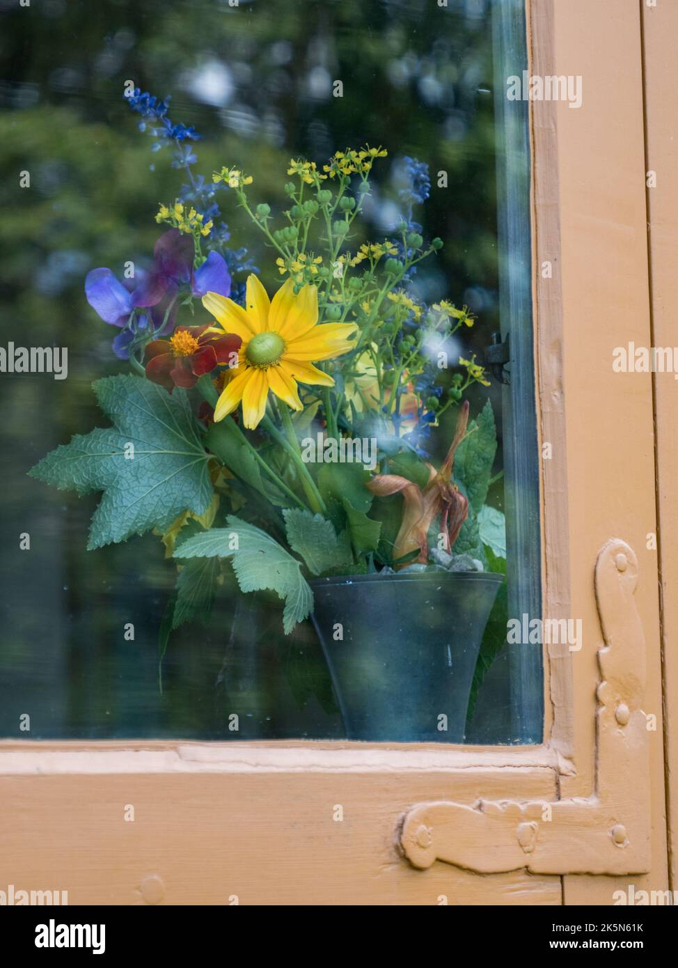 An old retro style window with flowers . A typical old style country ...