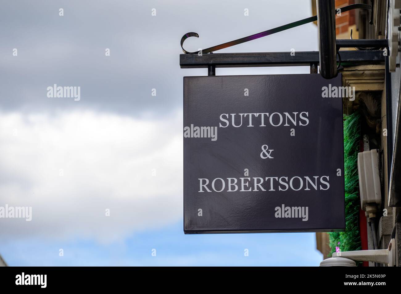 LONDON - May 21, 2022: Traditional old shop sign for Suttons and ...