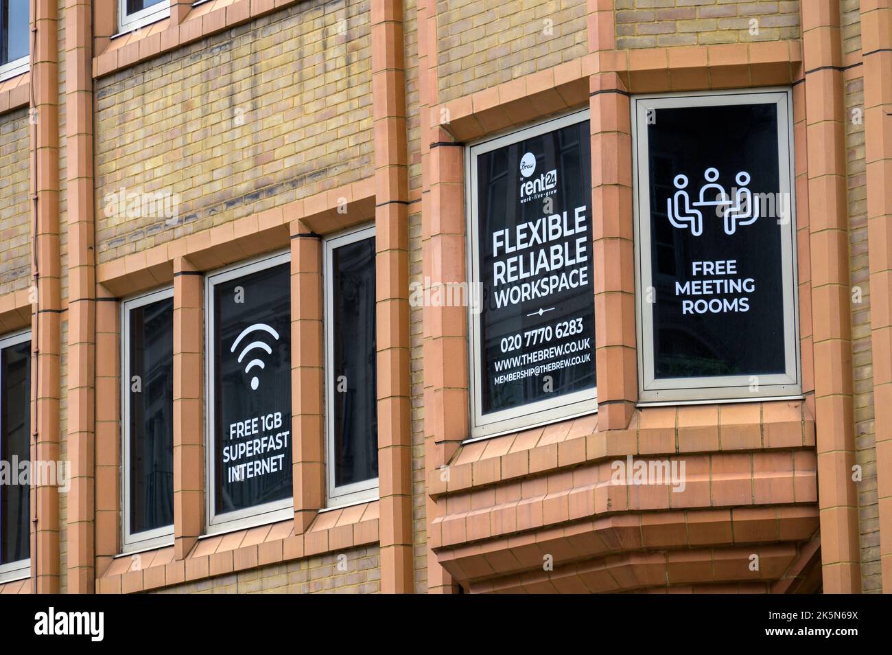 LONDON - May 21, 2022: Flexible workspace rental signs in windows of ...
