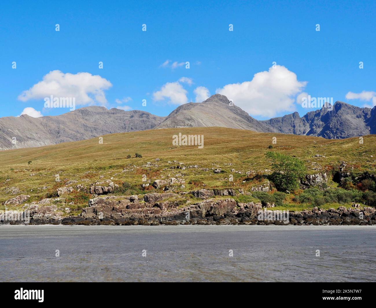 A scenic view of rocky mountains under the clear sky at Glen Brittle ...