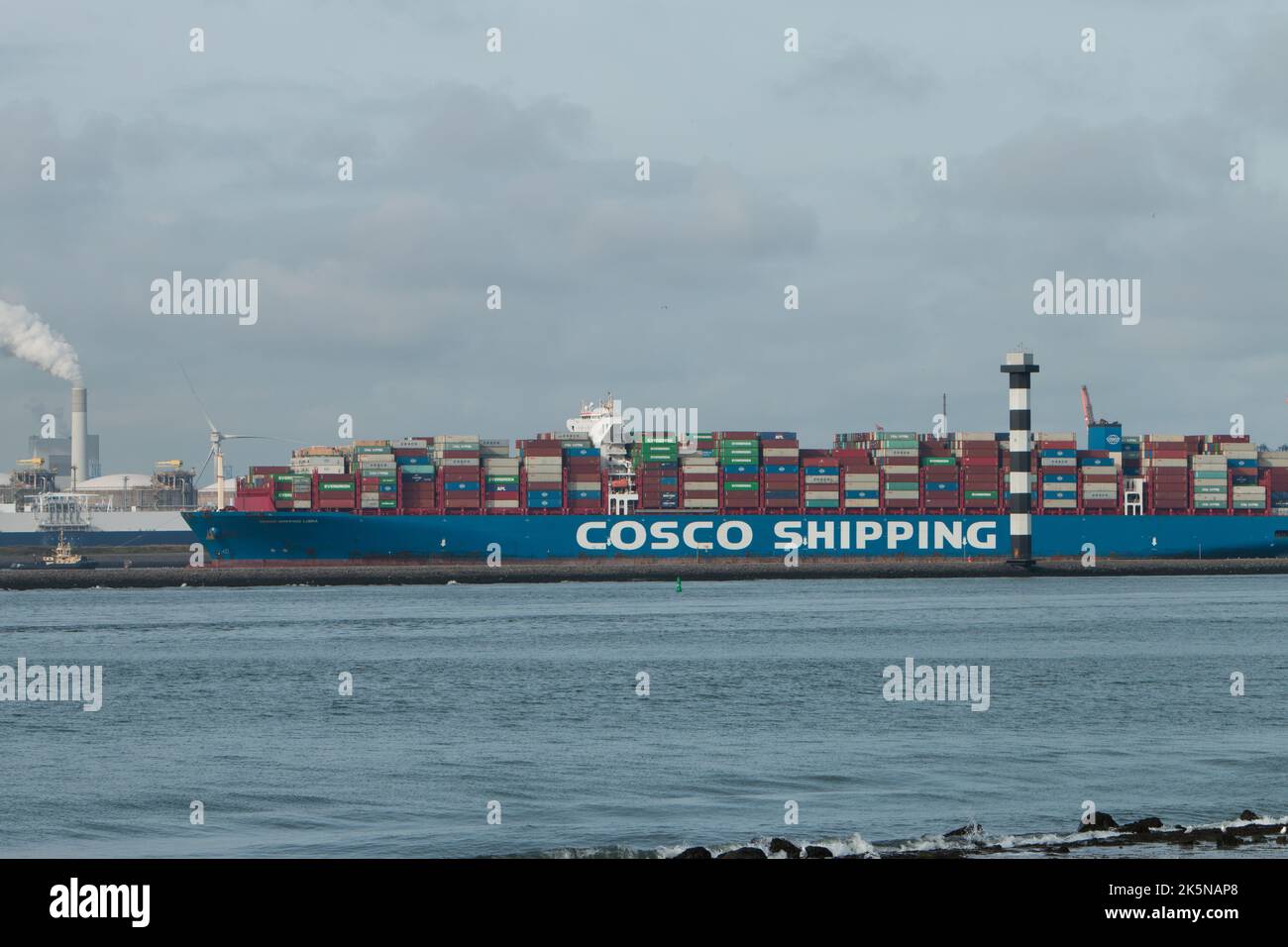 Cosco Shipping container ship moving up waterway towards port. Viewed ...