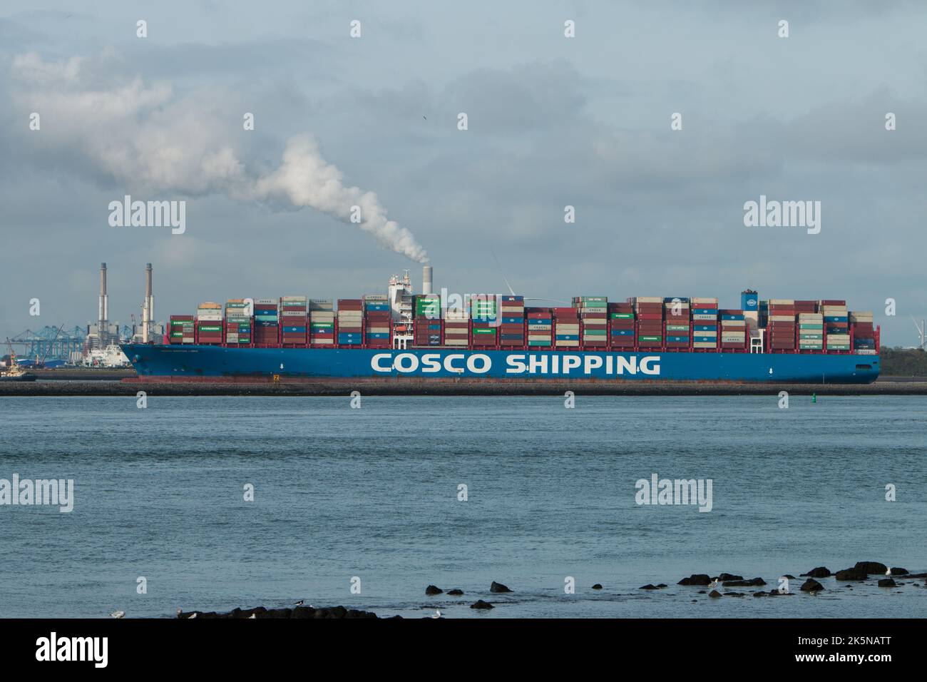 Cosco Shipping container ship moving up waterway towards port. Viewed ...