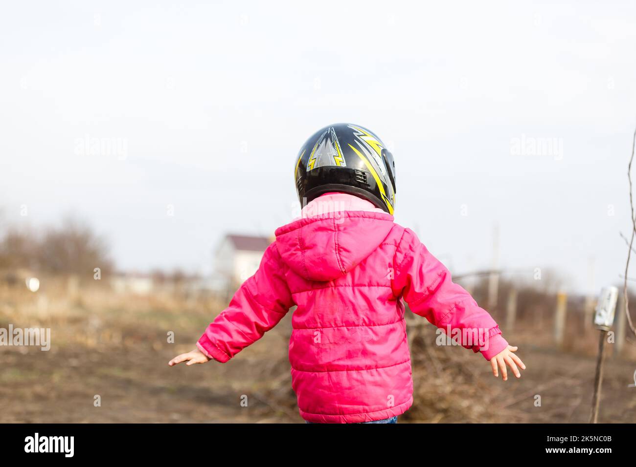 portrait of a little girl smiling in a protective helmet female child ...