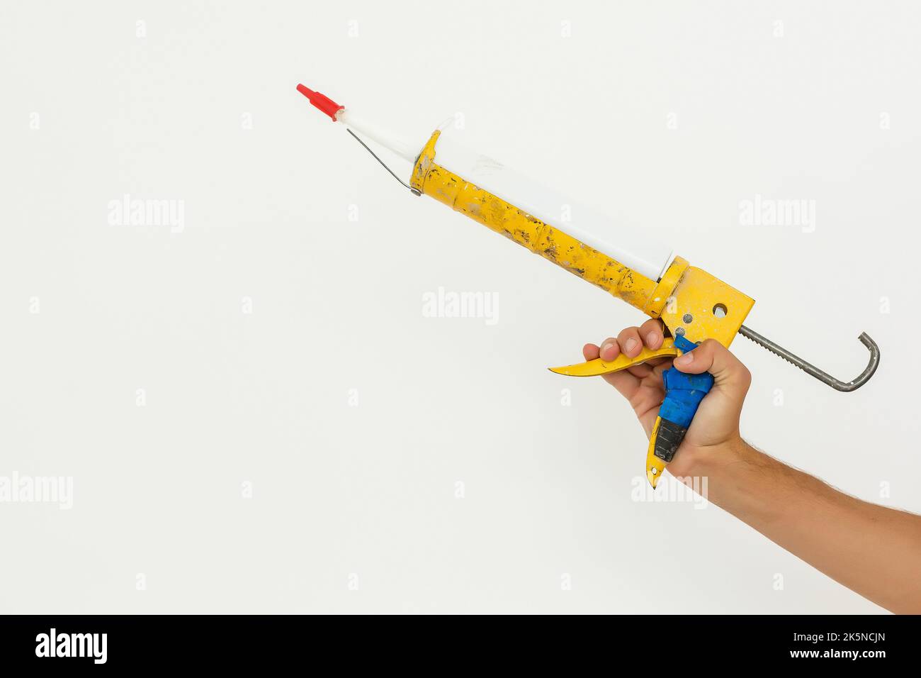 Hand holding glue gun isolated on the white background Stock Photo - Alamy