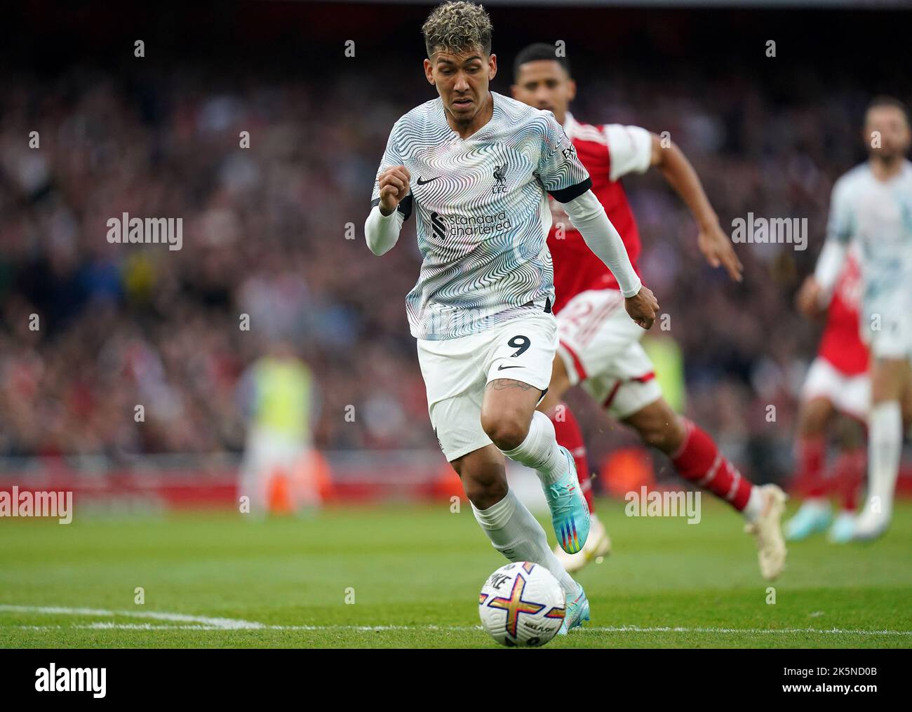 Liverpool's Roberto Firmino lines up the shot before scoring their side ...