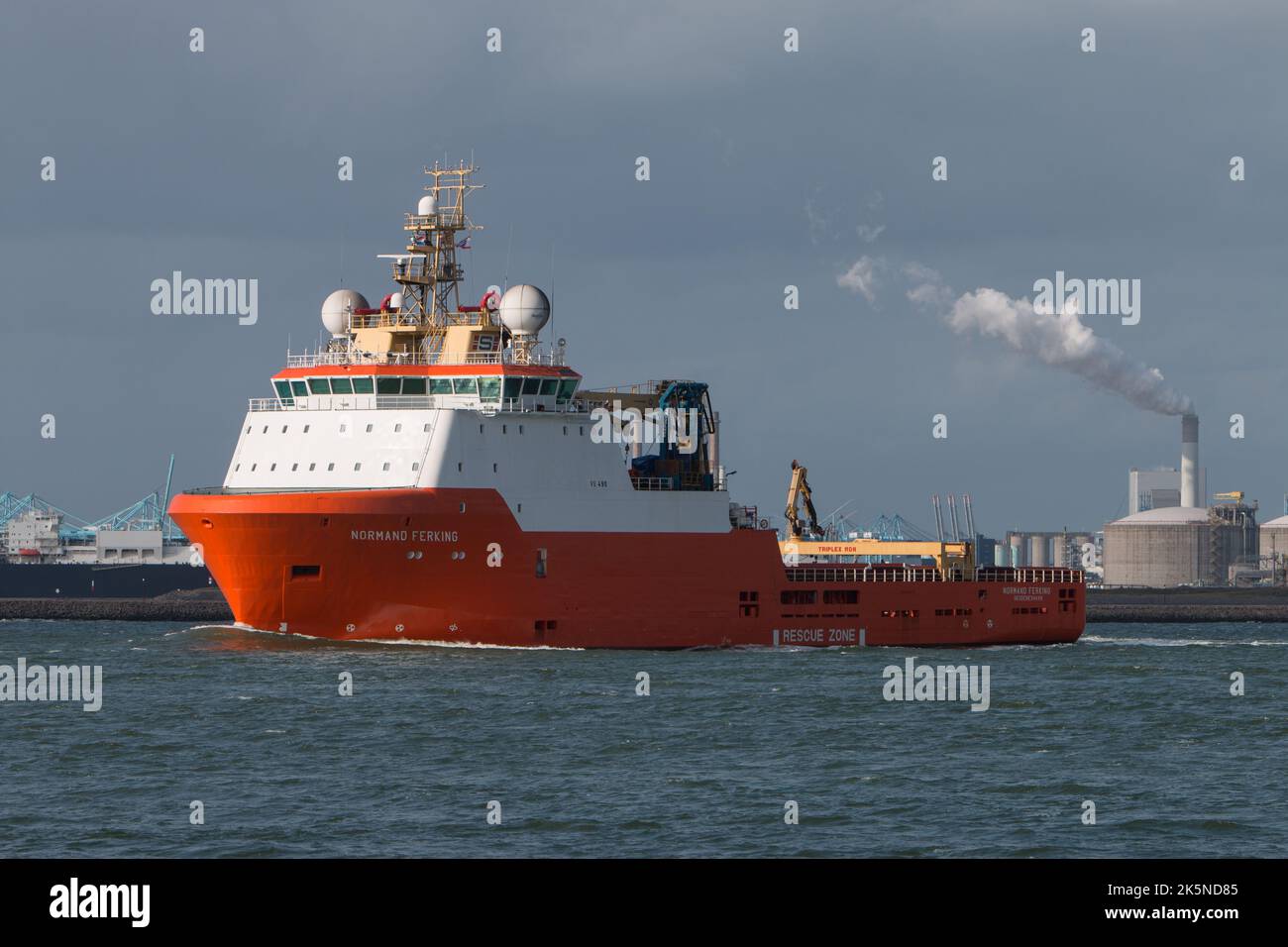 Commercial ship heading up waterway with docks in the background ...