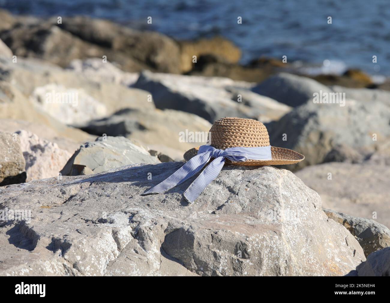 straw hat on the rocks is a symbol of vacation and experience Stock ...