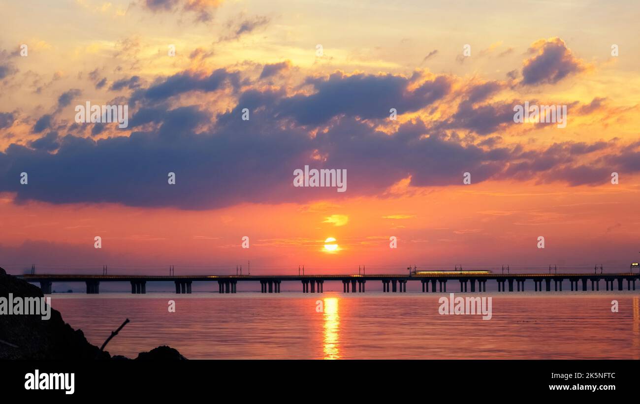 A scenic view of Shishu lake and bridge at sunset with the yellow ...