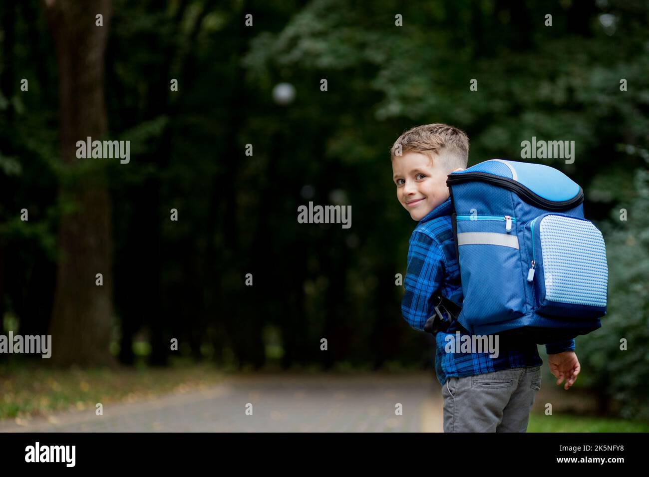 Little boy with backpack going to school. Rear view. First grader Stock ...
