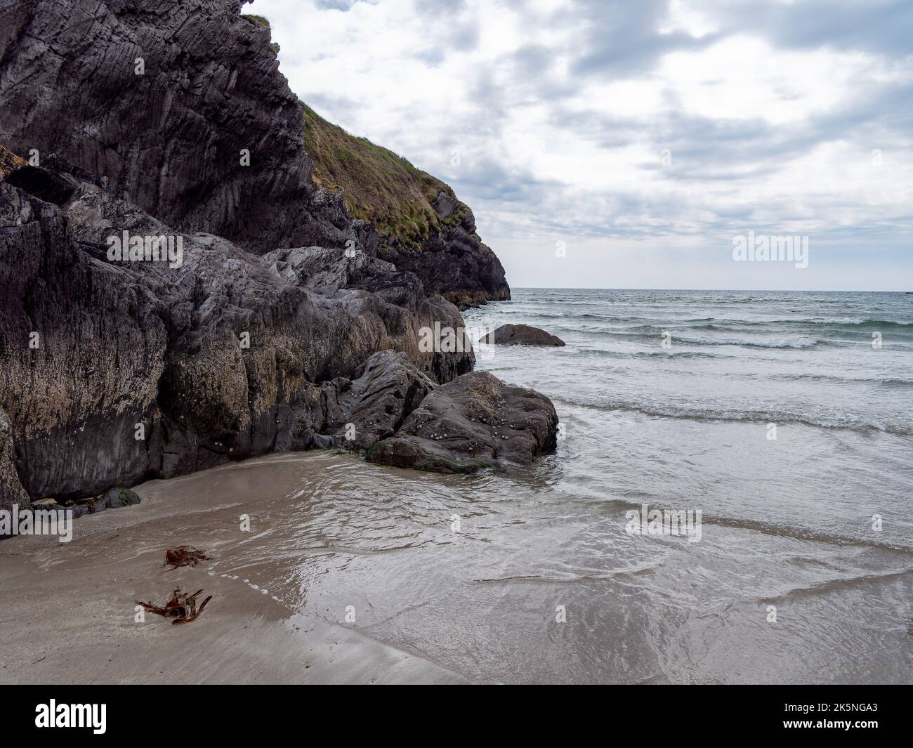 Sheer cliffs at Warren Beach. Beautiful sky. The picturesque coast ...
