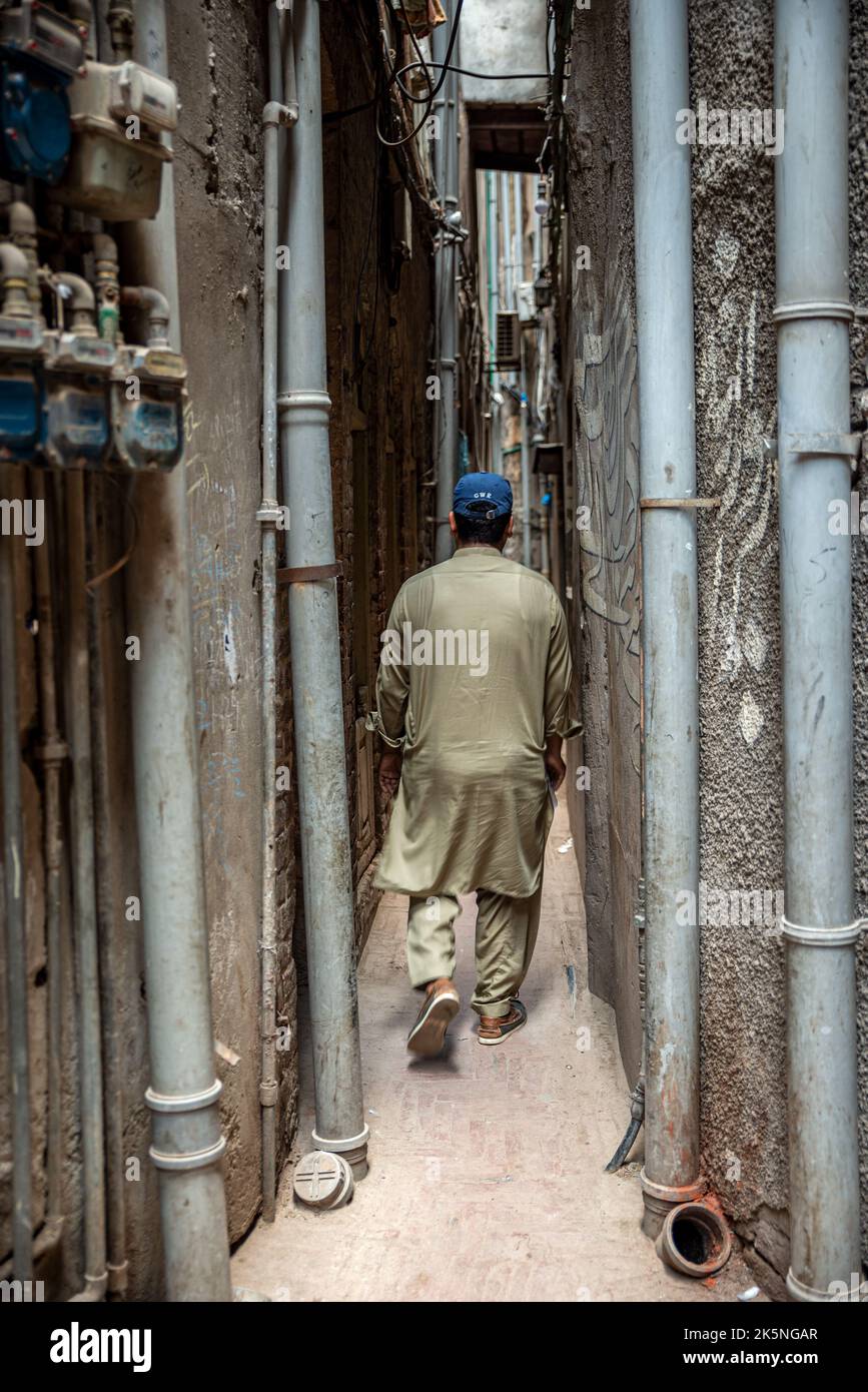 A very narrow alley in downtown with arabic inscriptions, Lahore ...